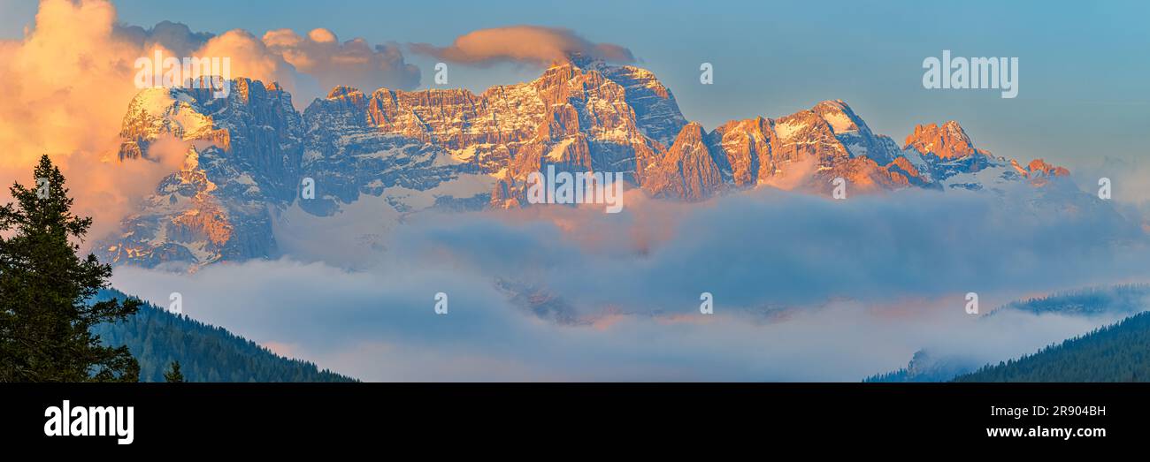 A wide 3:1 panoramic image from first morning light during sunrise over ...