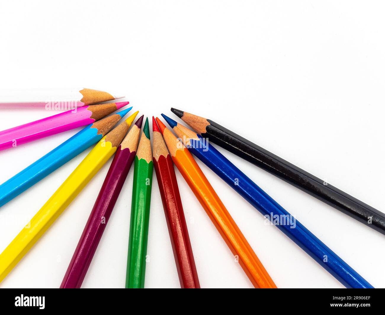 An array of assorted colored pencils in a circular formation against a ...