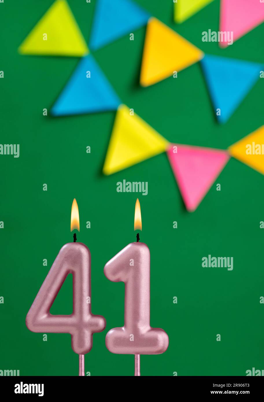 Number 41 candle - Birthday celebration on green background Stock Photo ...