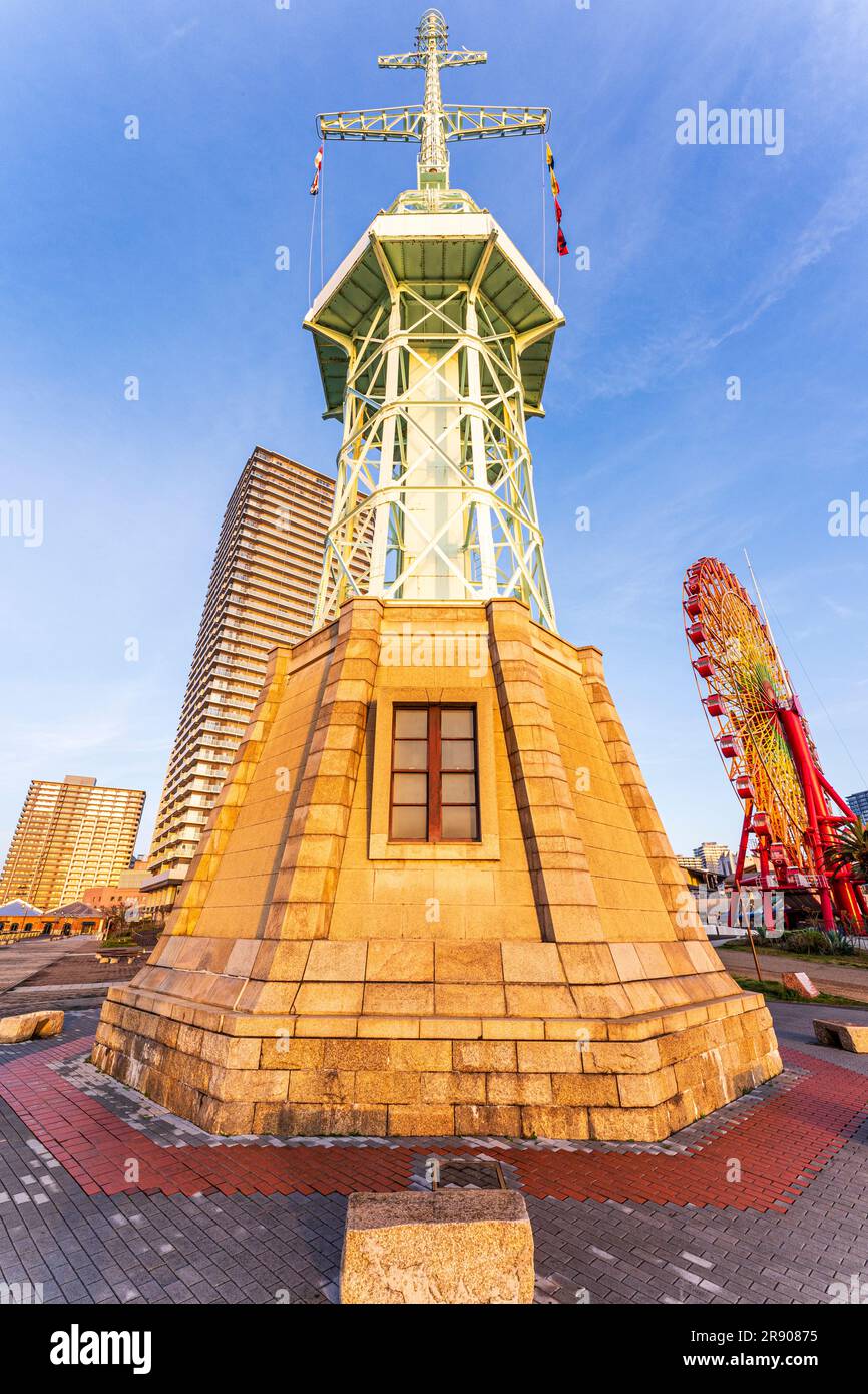Low angle view of the former Kobe Port Signal station against a blue ...