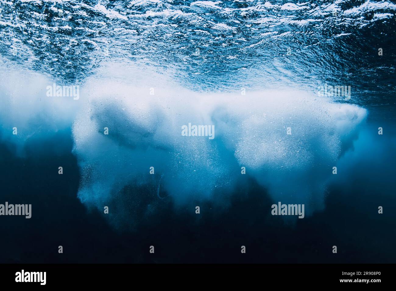 Ocean wave with foam underwater in blue water Stock Photo - Alamy