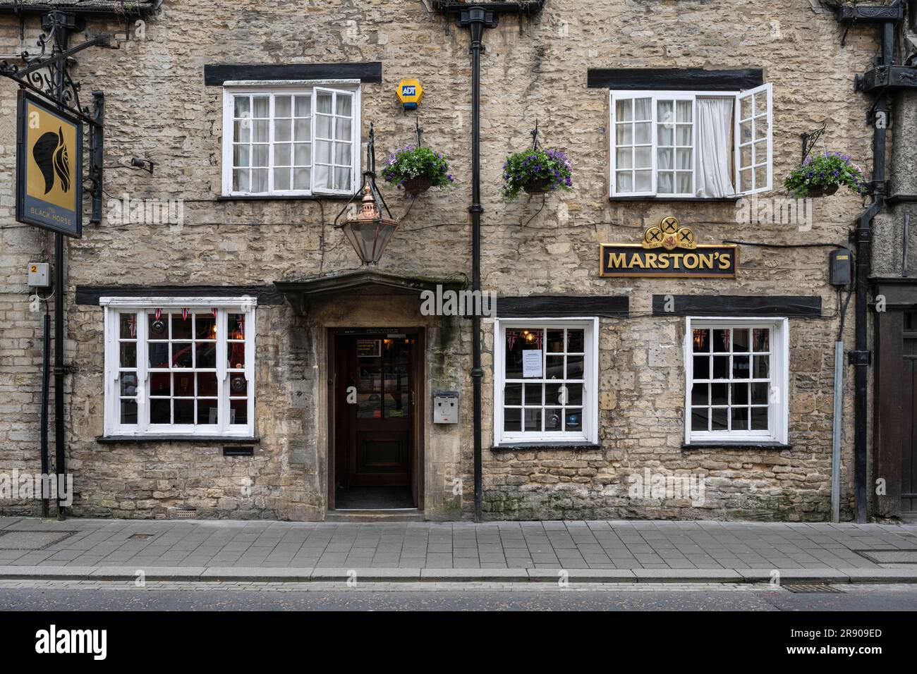 Old stone house with pub in detail in the old town of Cirencester ...