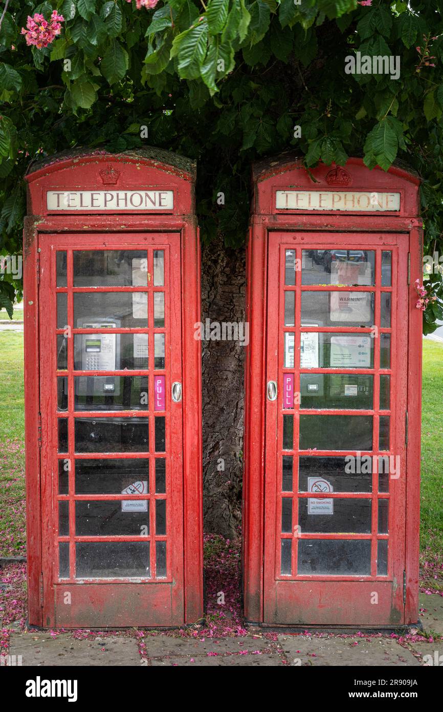 Old, dilapidated British telephone boxes on the high street of Broadway ...
