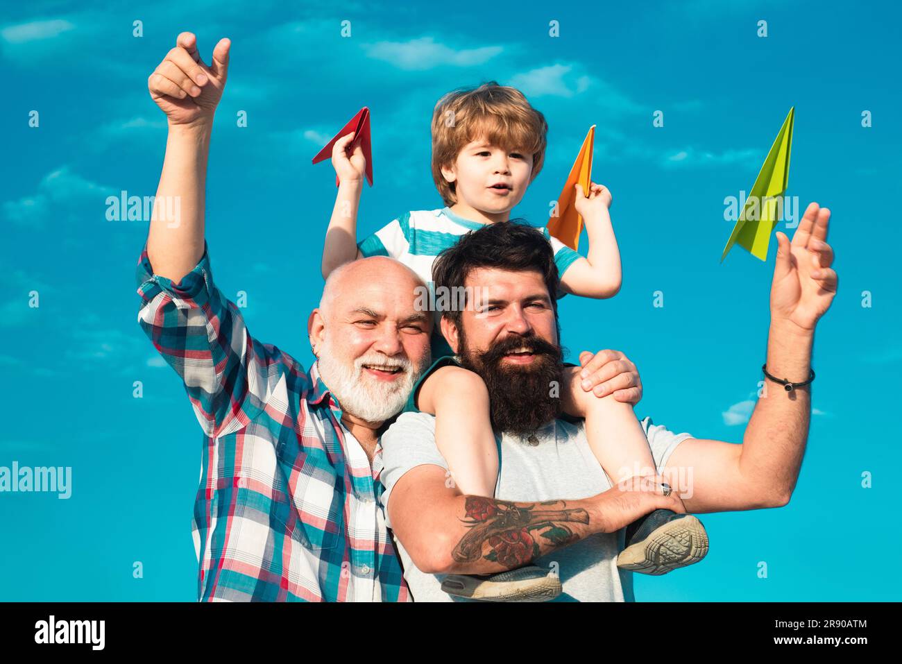 Men generation: grandfather father and grandson are hugging looking at ...