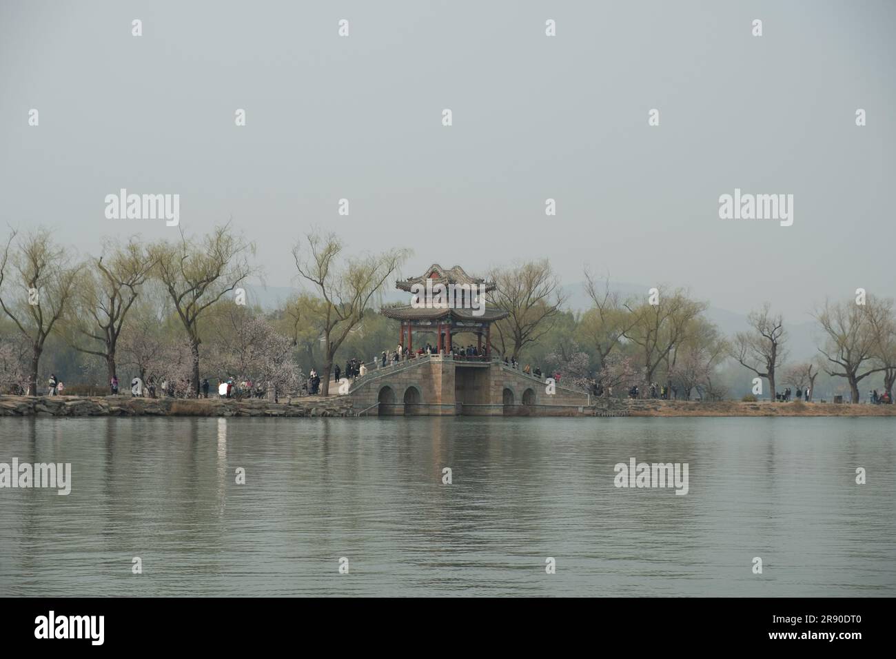 A crowd of people crossing the bridge in the Summer Palace complex ...