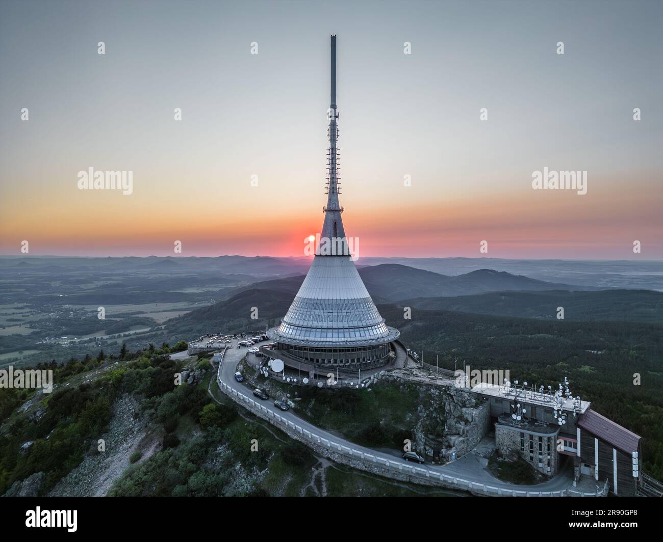 Sunset behind Jested Mountain with unique building on the summit ...