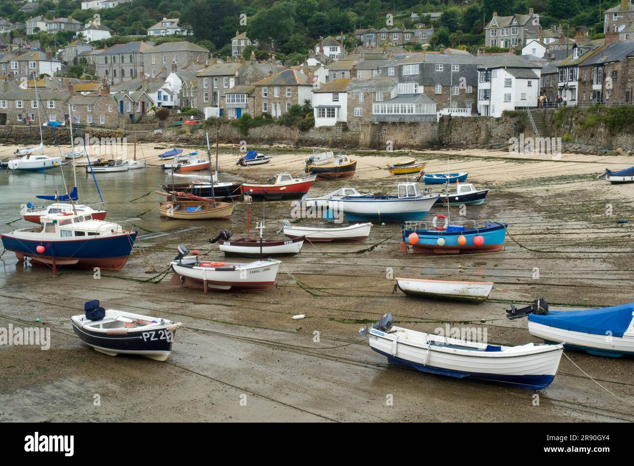 Boats in harbour, low tide, Mousehole, Cornwall, England, United ...