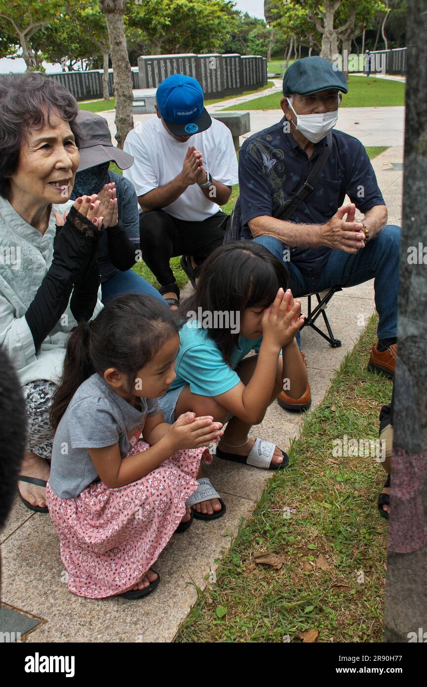 Itoman, Japan. 23rd June, 2023. A bereaved family pray for victims at the Peace Memorial Park in ...
