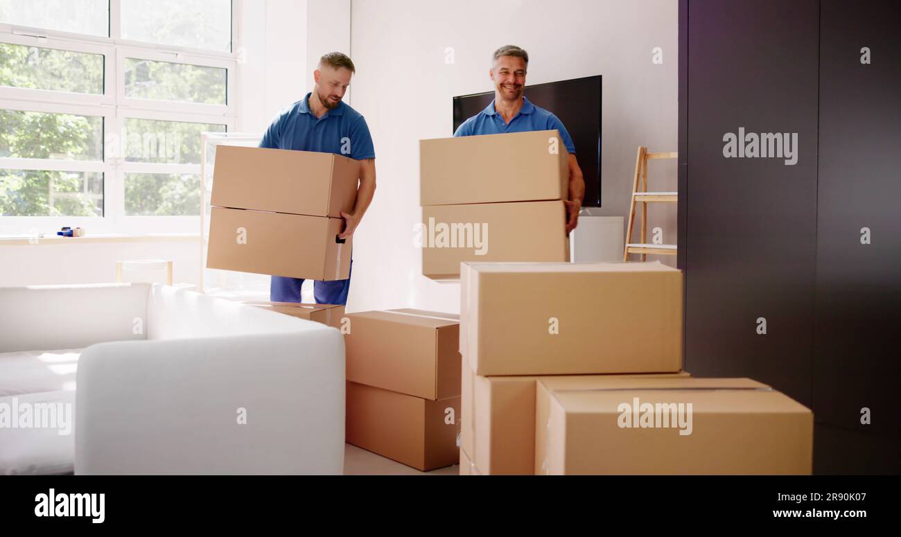 Movers Delivering Packaging Boxes. Moving And Relocation Stock Photo ...