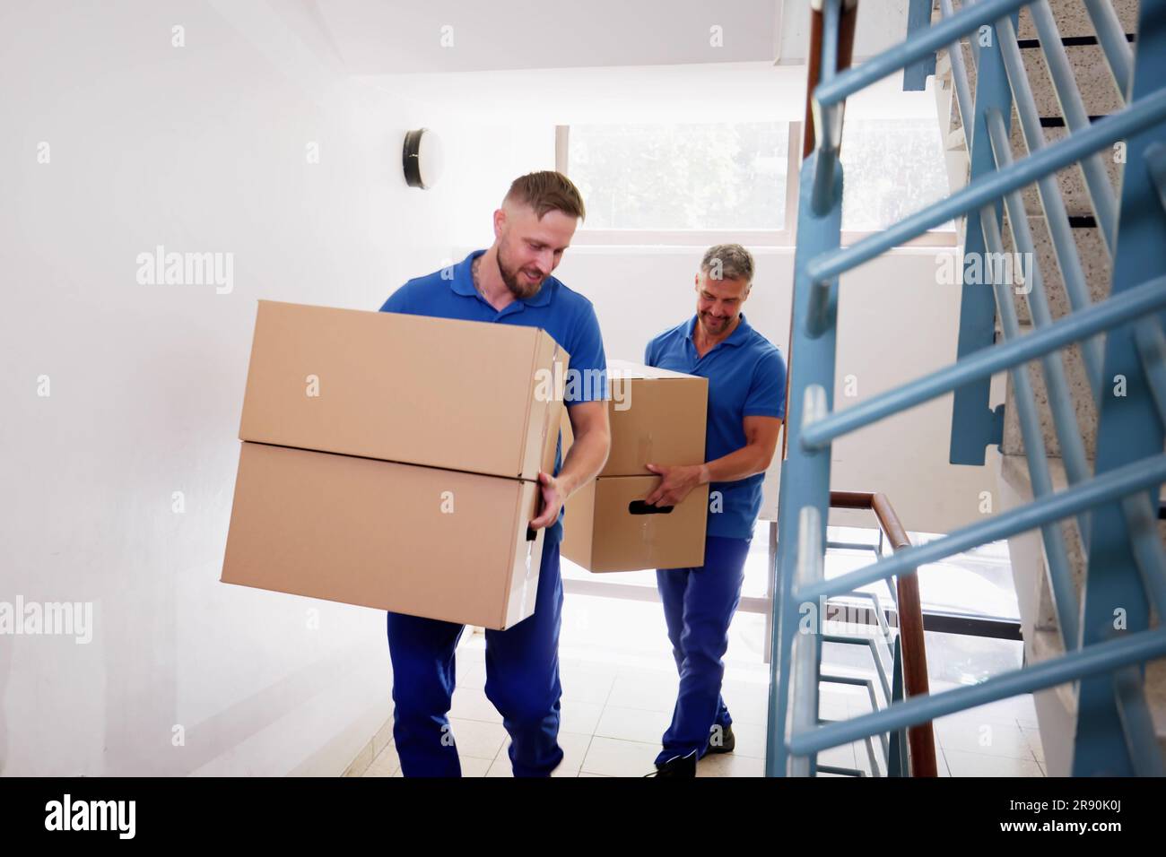 Overseas Relocator Movers Delivering Boxes. Men Moving Parcel Stock ...