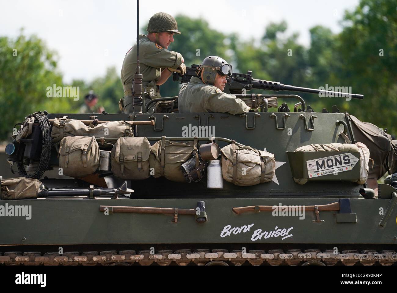 A tank crew sit in their M18 Hellcat tank as they wait to enter the ...