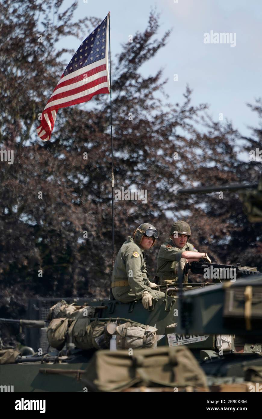 A tank crew sit in their M18 Hellcat tank as they wait to enter the ...