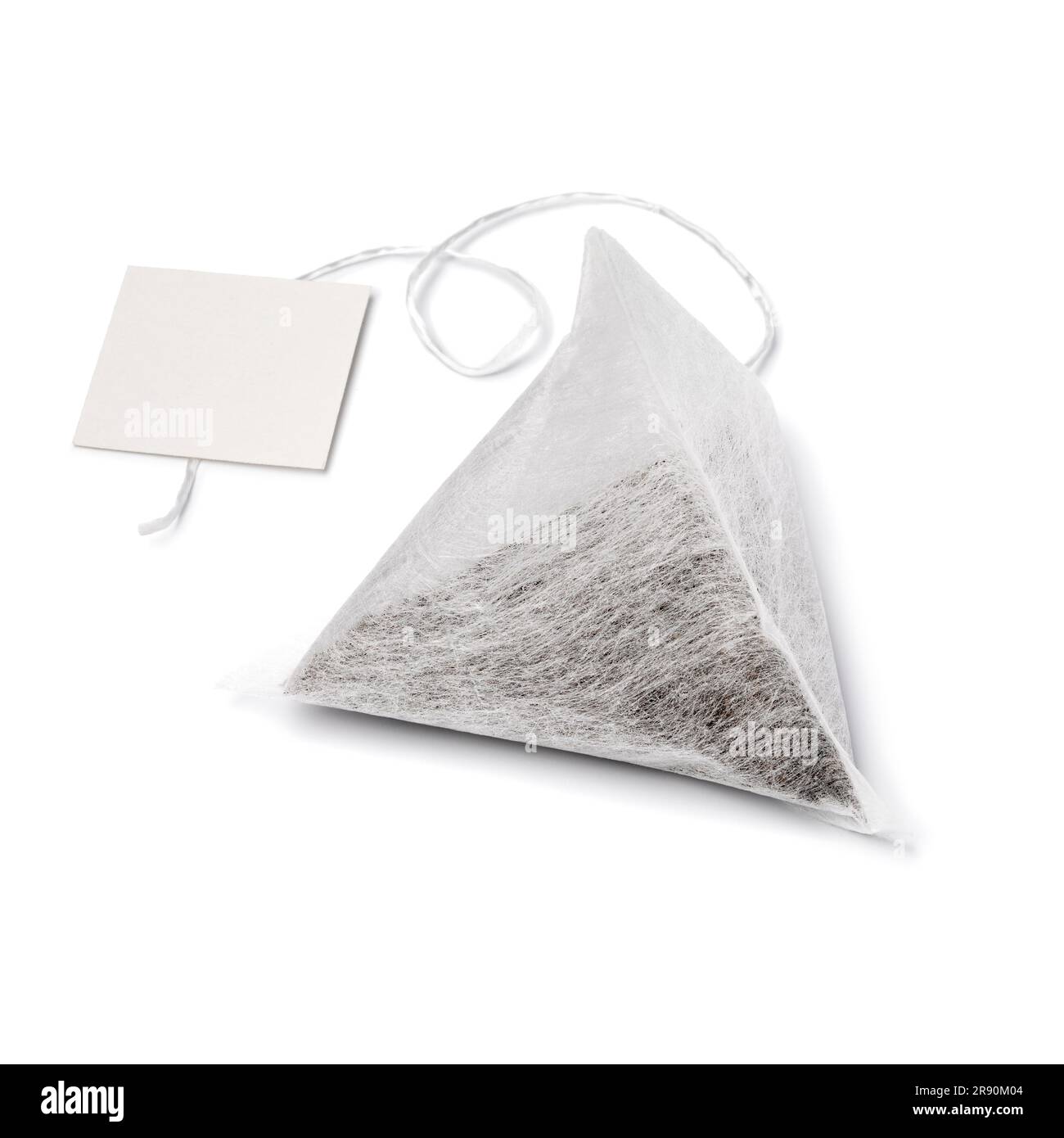 Single pyramid tea bag and blank label isolated on white background ...