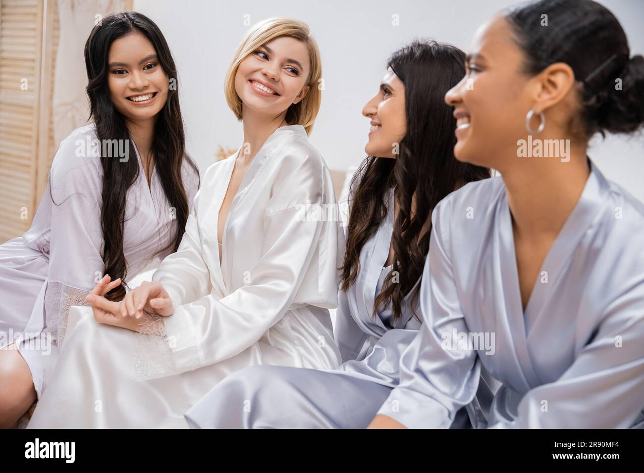 bridal party, silk robes, female friends, bride with her multicultural ...