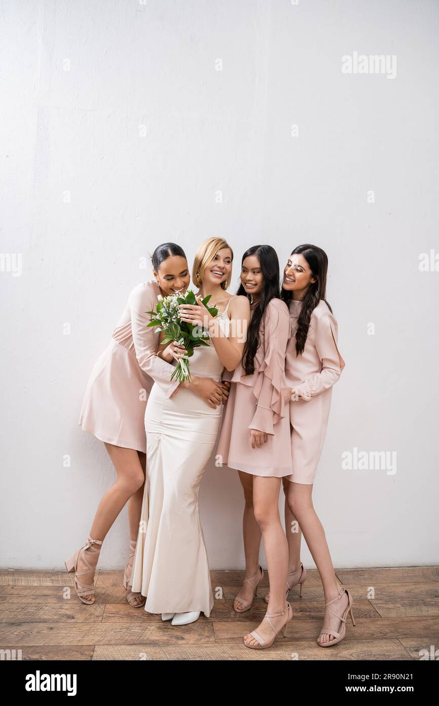 excitement, happy multicultural bridesmaids hugging bride in wedding ...