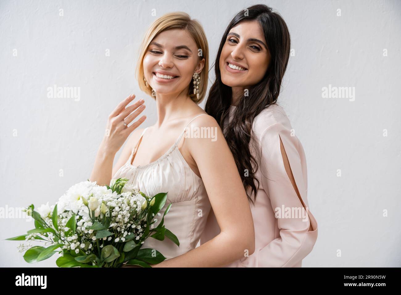 special occasion, bridesmaid hugging bride, showing engagement ring ...