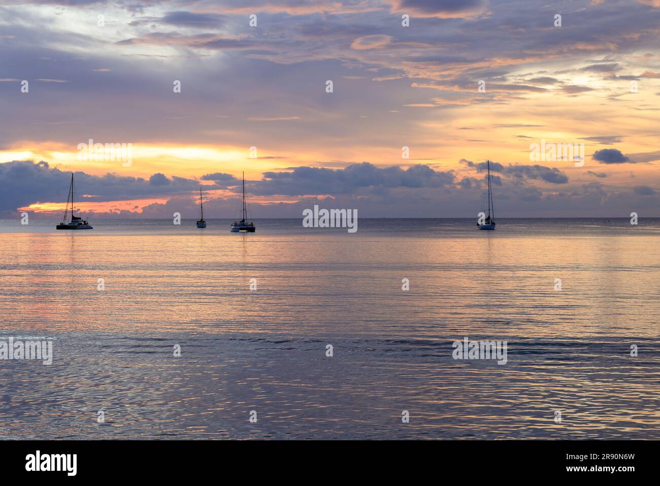 Magical sun setting on the beach of Naiyang on the island of Phuket in ...