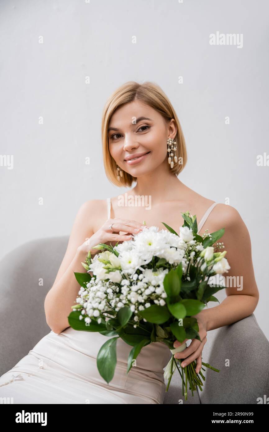 special occasion, beautiful blonde bride in wedding dress sitting in ...