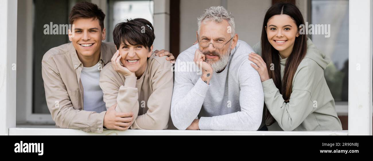 parents day, middle aged parents smiling next to teenage daughter and ...