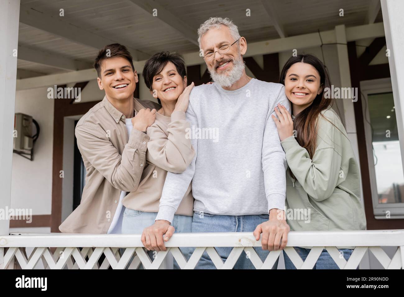 parents day celebration, middle aged parents hugging with cheerful ...