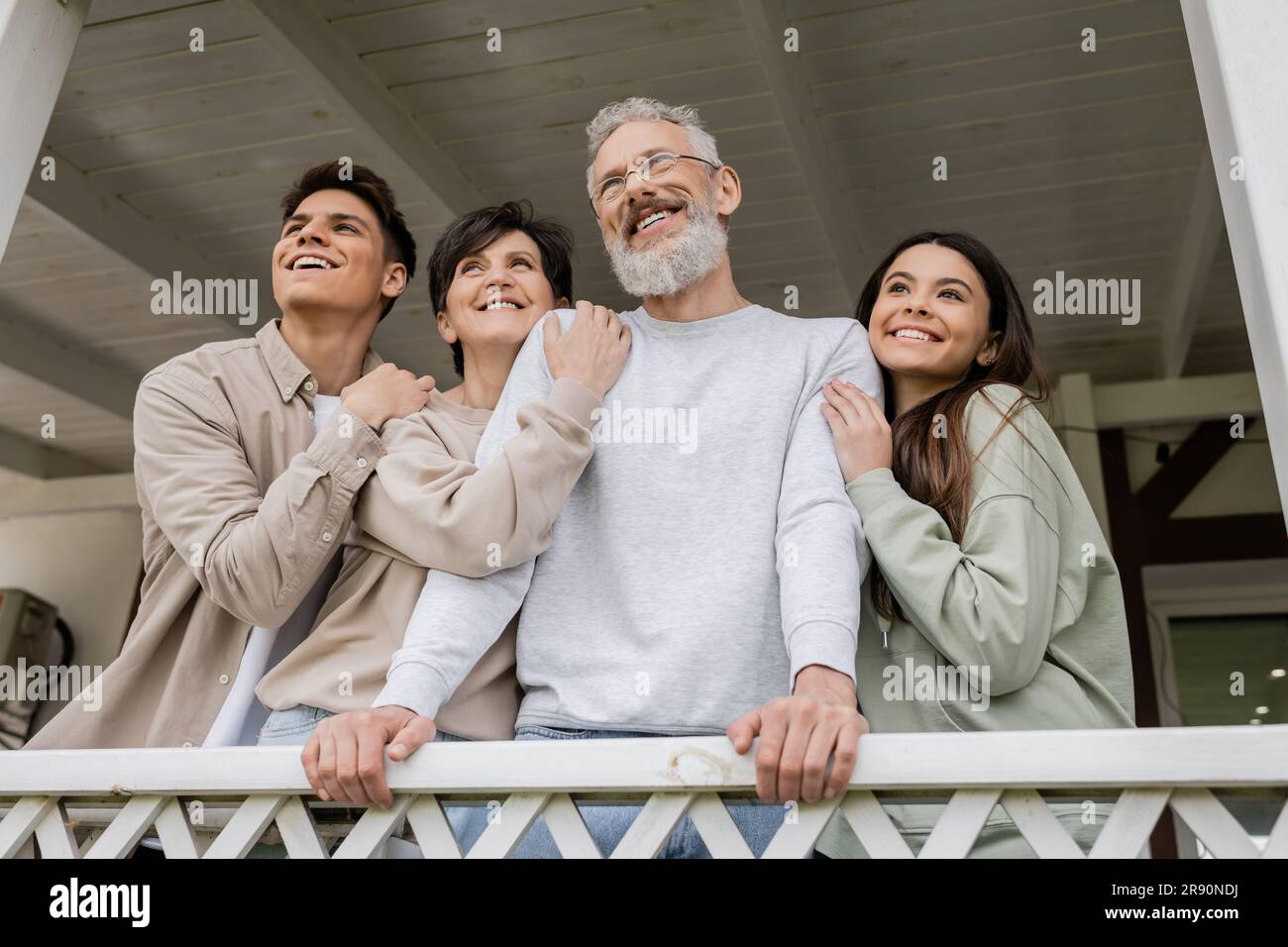 celebration of parents day, middle aged parents hugging with happy ...