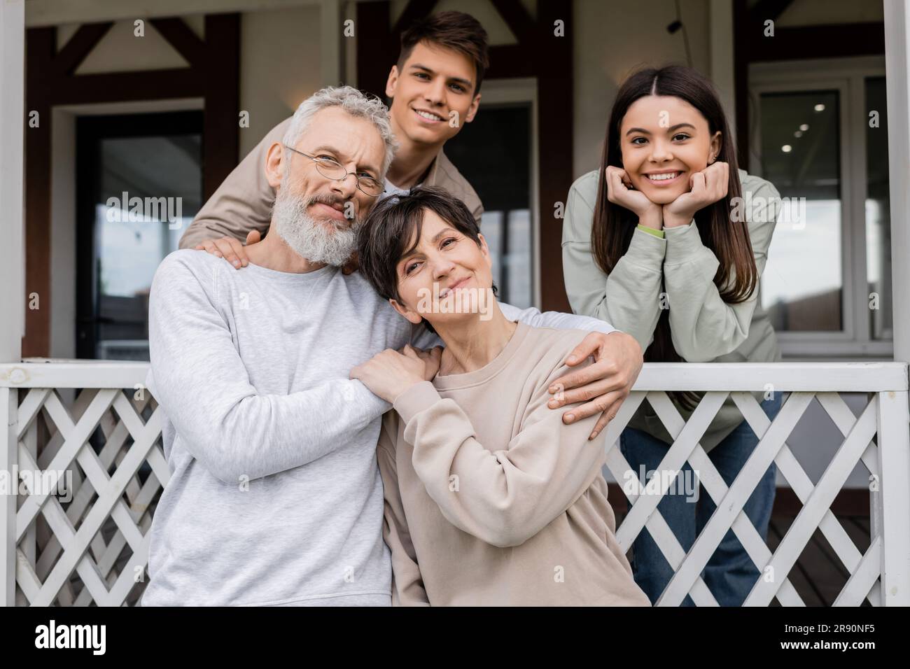 family photo, happy parents day, middle aged parents hugging near ...