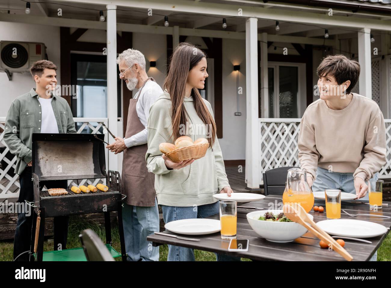 parents day, happy teenage girl helping mother, holding buns, serving ...