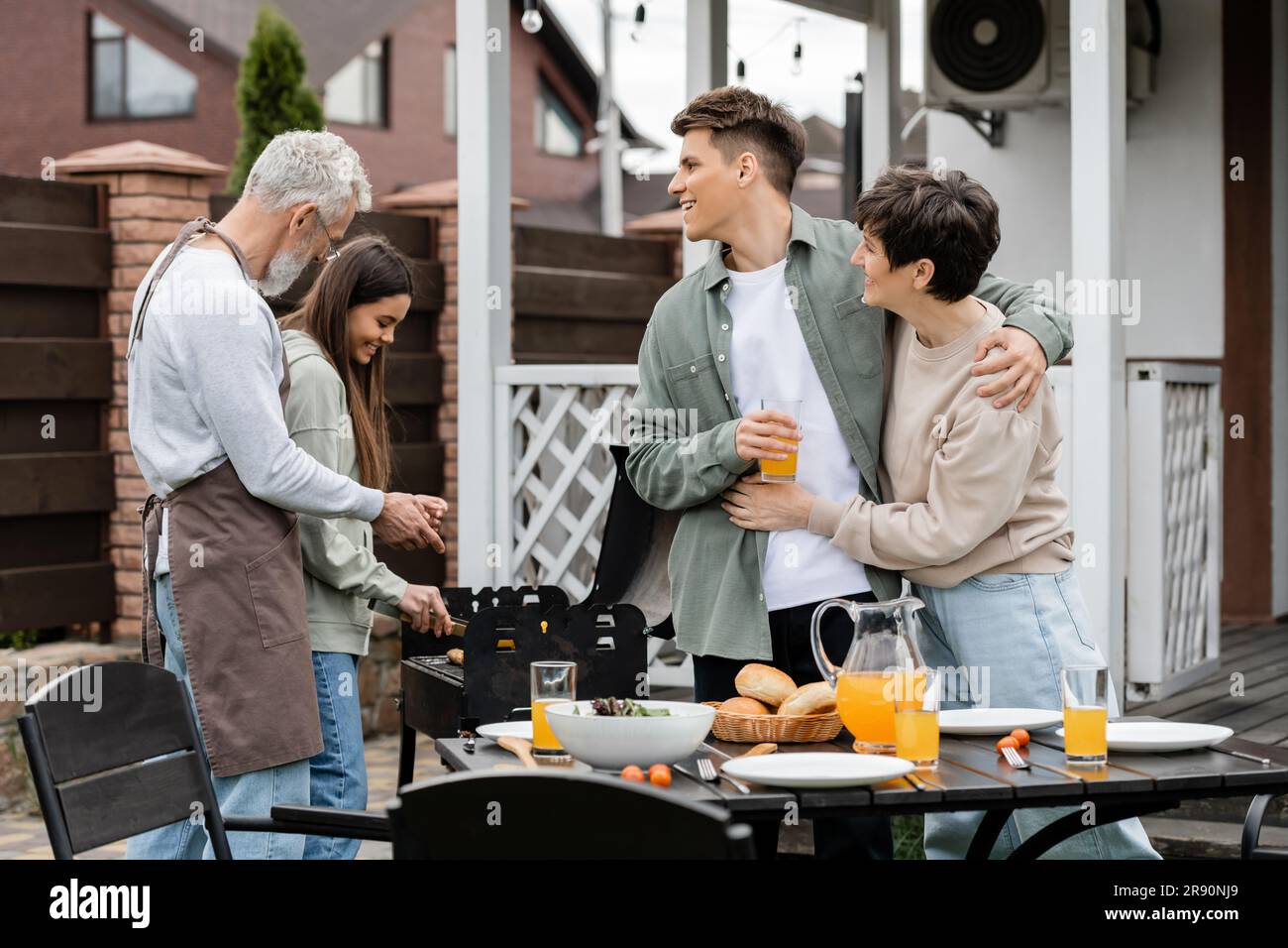 modern parenting, happy parents day, middle aged mother hugging with ...