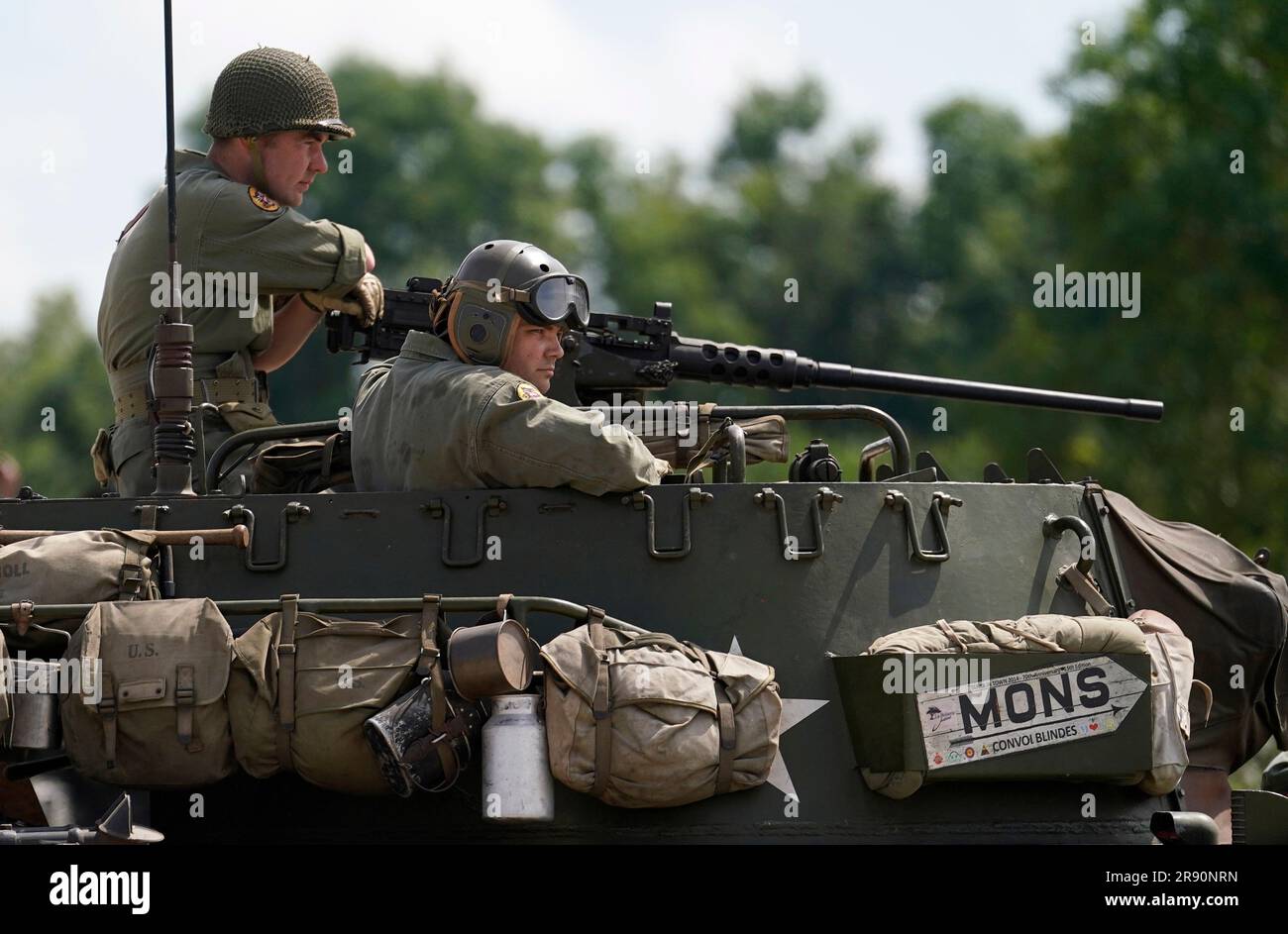A tank crew sit in their M18 Hellcat tank as they wait to enter the ...