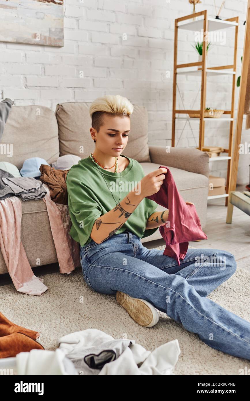 Casually Styled And Tattooed Woman With Trendy Hairstyle Sitting On