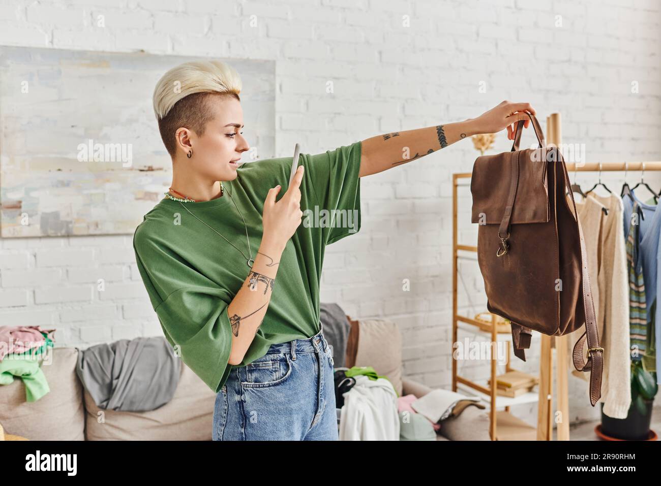 sorting clothes, online exchange, tattooed woman taking photo of ...
