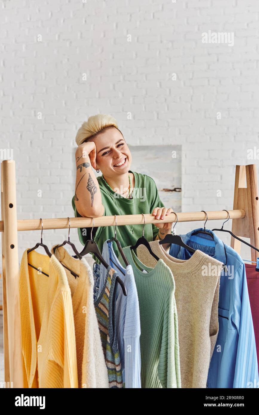 Woman sorting clothes on rack hi-res stock photography and images - Alamy