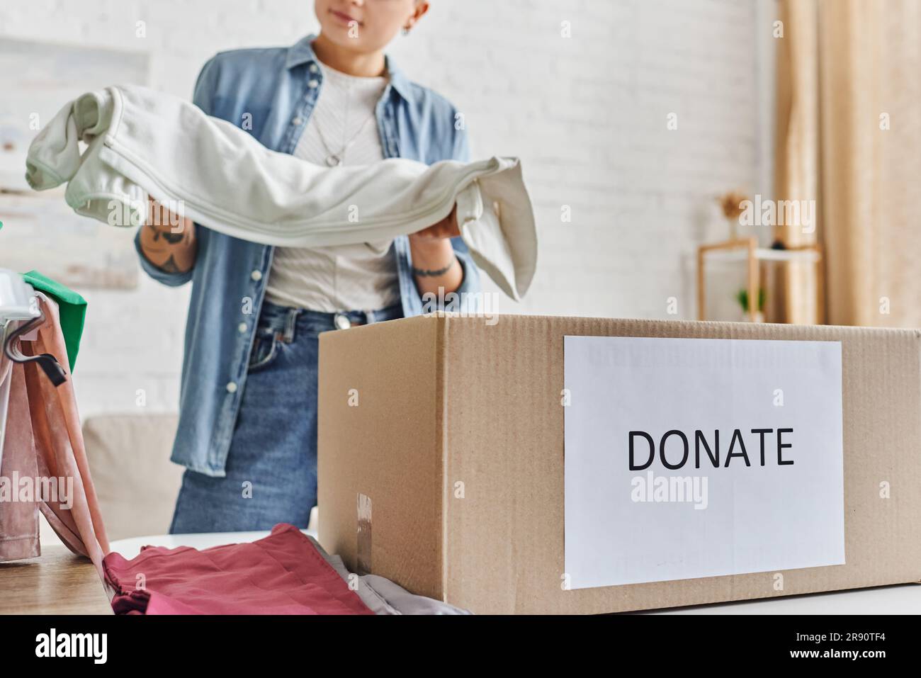 promoting social good, partial view of tattooed woman in casual clothes ...