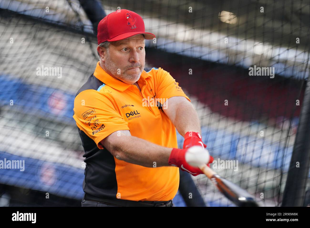 CEO of McLaren Racing, Zak Brown, attempts to hit the ball during a ...