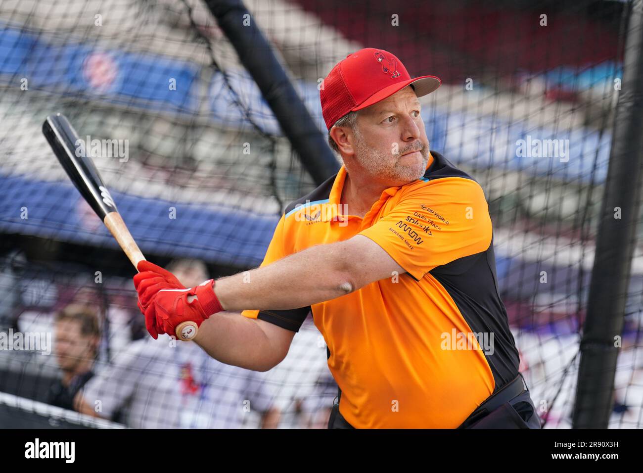 CEO of McLaren Racing, Zak Brown, attempts to hit the ball during a ...