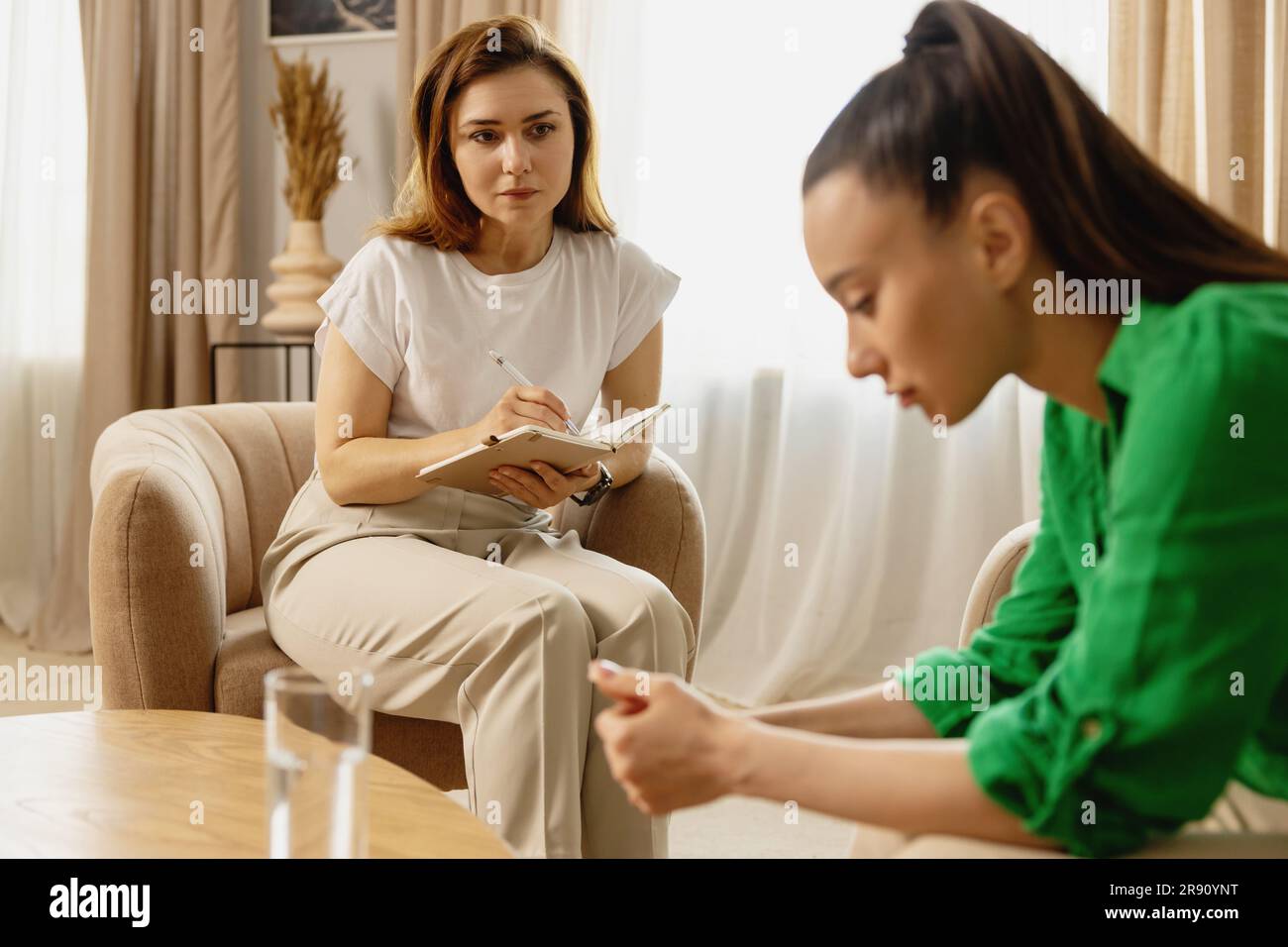 Closeup of sad woman sitting at psychologist's therapist appointment ...
