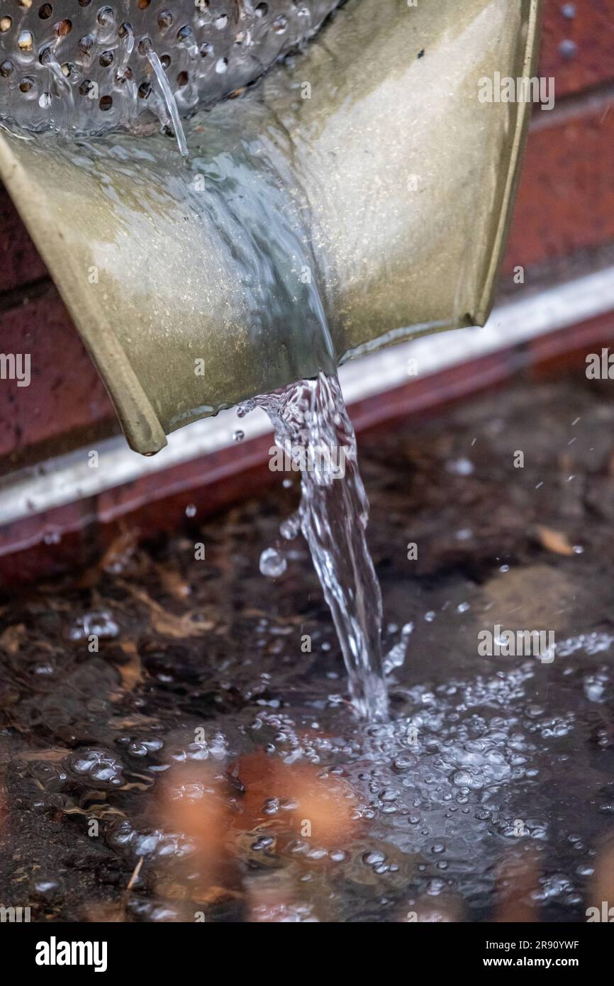 Water exiting a drain spout Stock Photo - Alamy