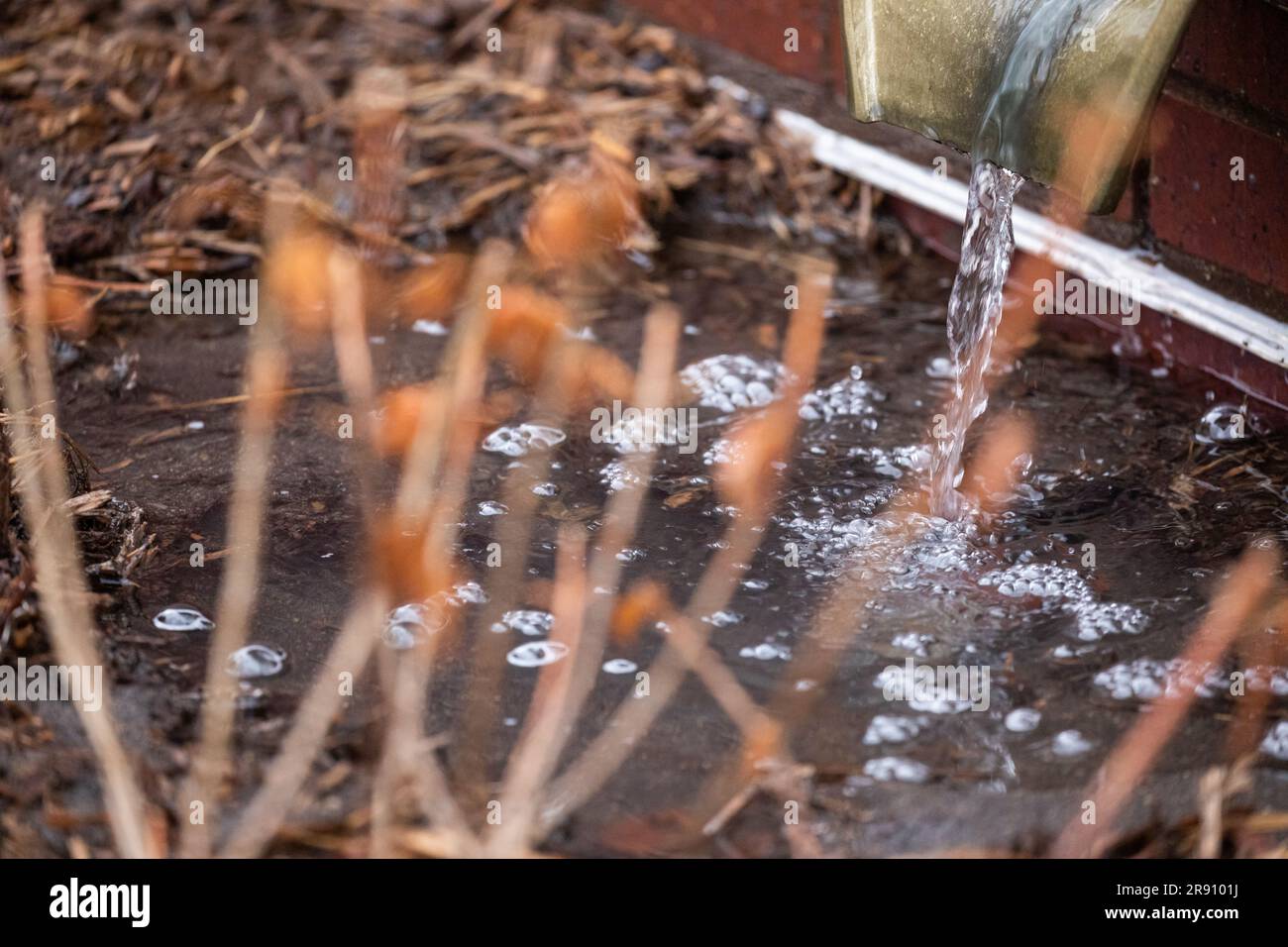 Water exiting a drain spout Stock Photo - Alamy