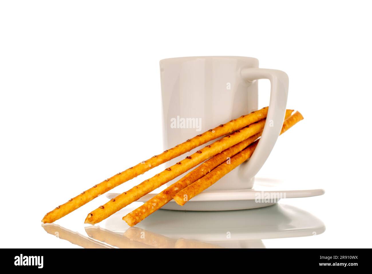 Straw is a bakery product. Several straws with white ceramic cup and ...