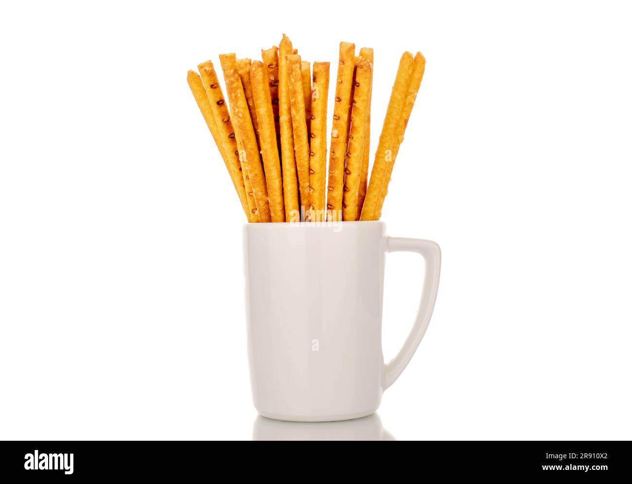 Straw is a bakery product. A few straws with a white ceramic cup, macro ...