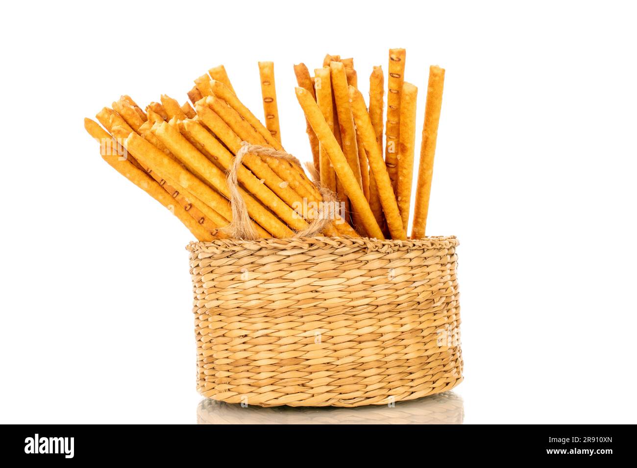Straw is a bakery product. Several straws in a straw basket isolated on ...