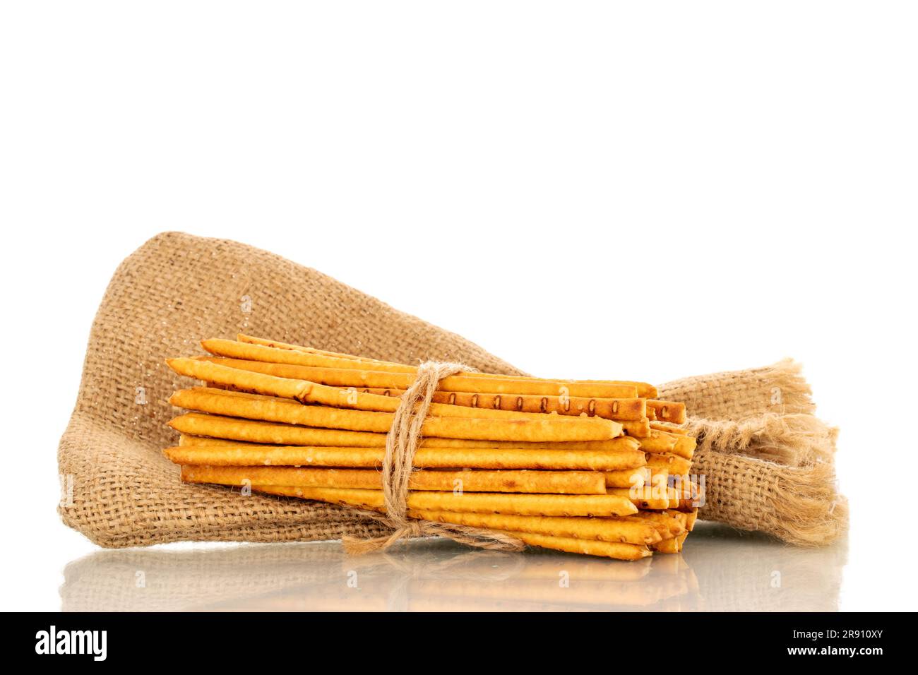 Straw is a bakery product. Several straws with a jute bag isolated on a ...