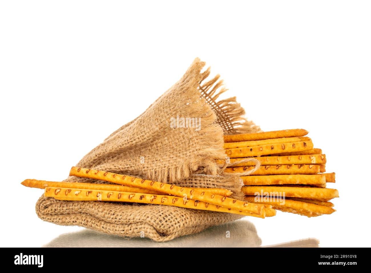Straw is a bakery product. Several straws with a jute bag isolated on a ...