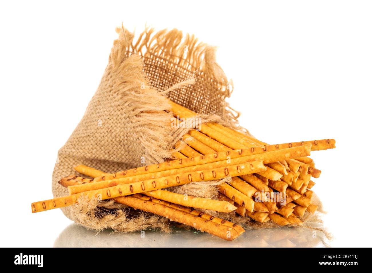 Straw is a bakery product. Several straws with a jute bag isolated on a ...