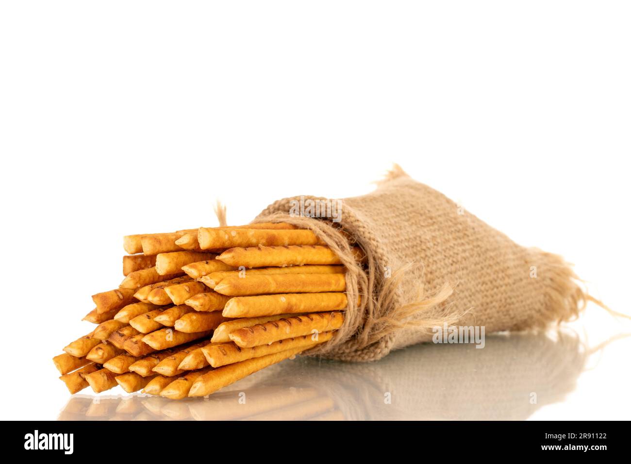 Straw is a bakery product. Several straws with a jute bag isolated on a ...
