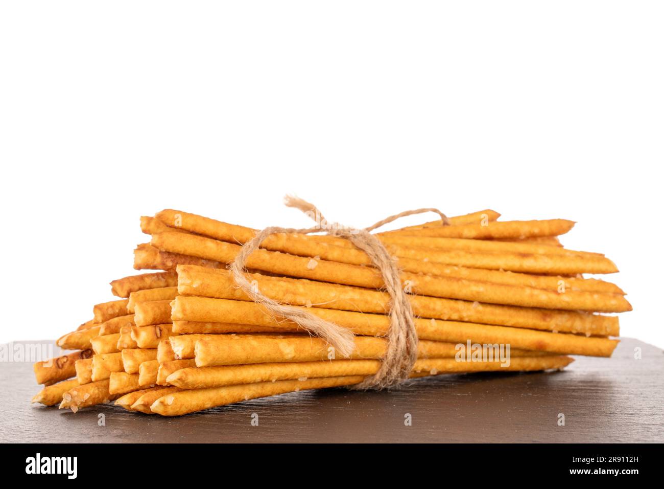 Straw is a bakery product. Several straws tied with jute string on ...