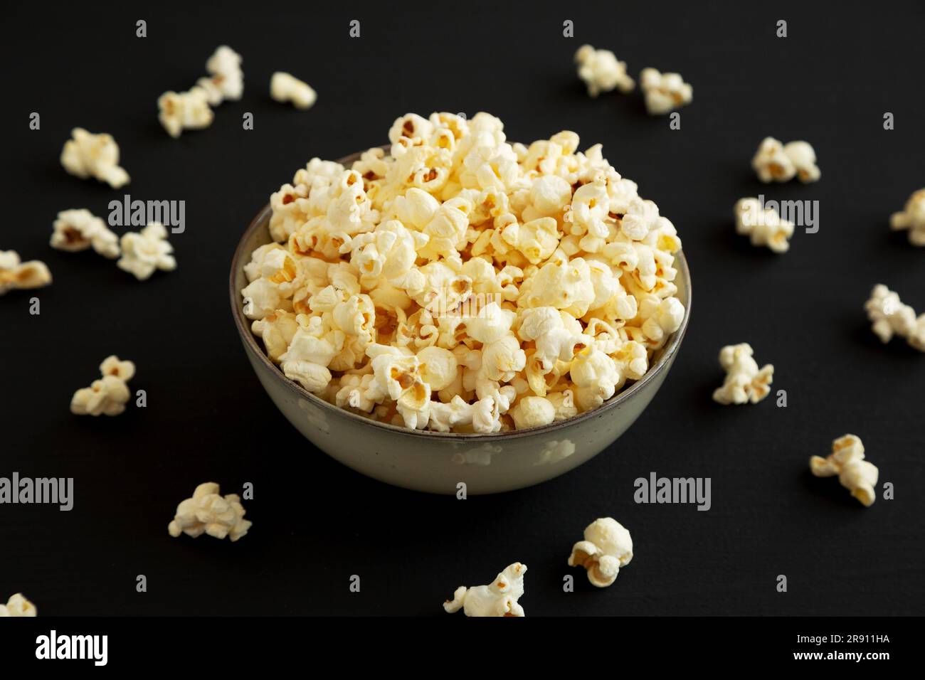 Homemade Buttered Popcorn with Salt in a Bowl on a black background ...