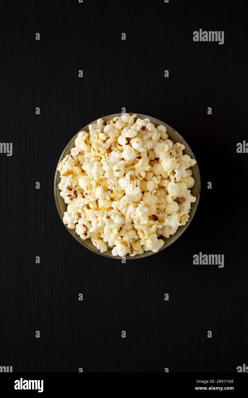 Homemade Buttered Popcorn with Salt in a Bowl on a black background ...