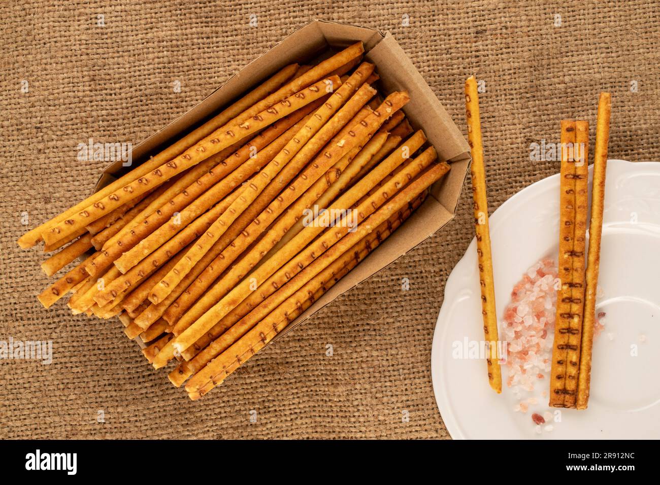 Straw is a bakery product. Several straws with paper plate and salt ...