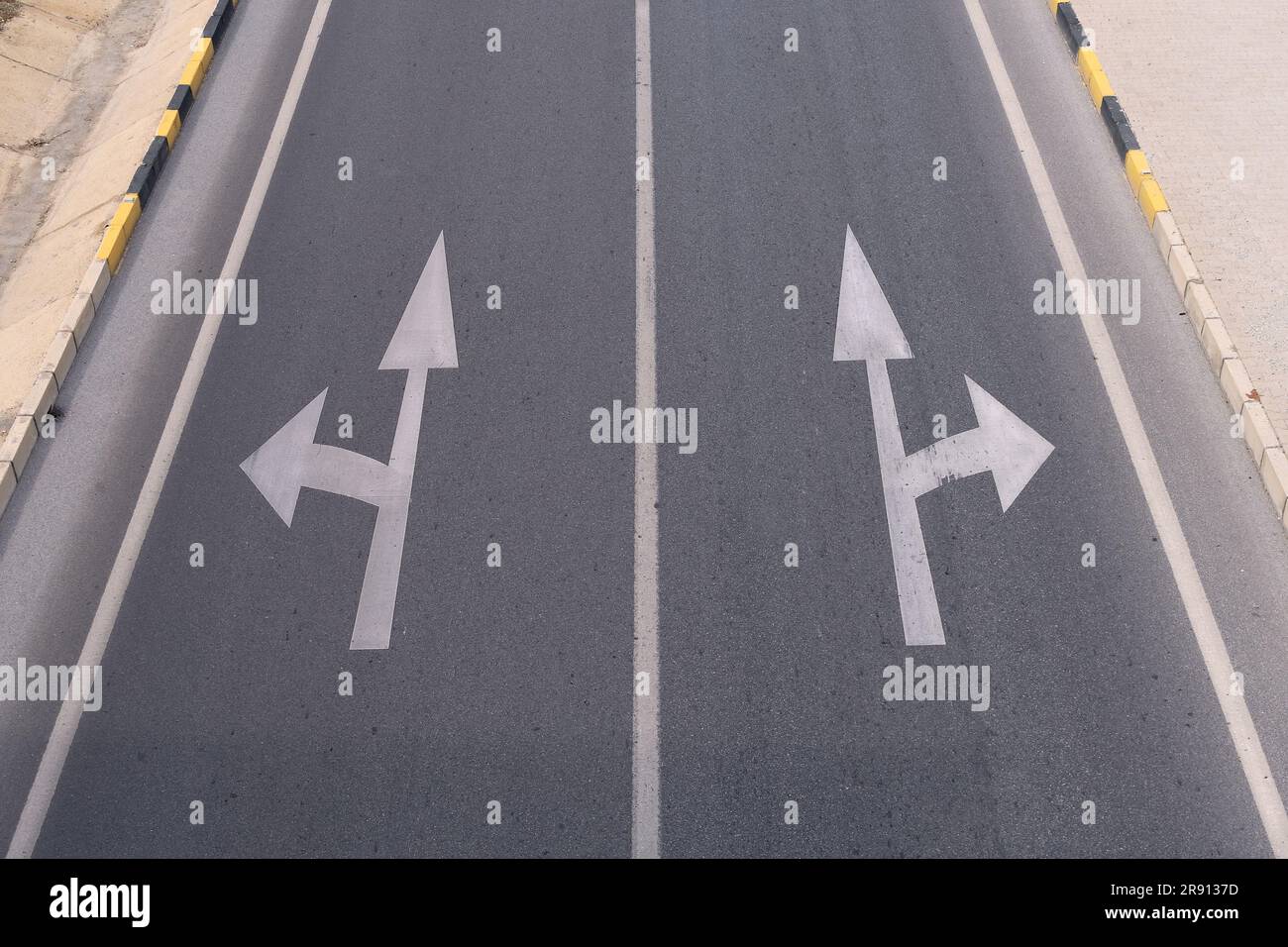 View from the top to the direction arrows on the asphalt road Stock ...